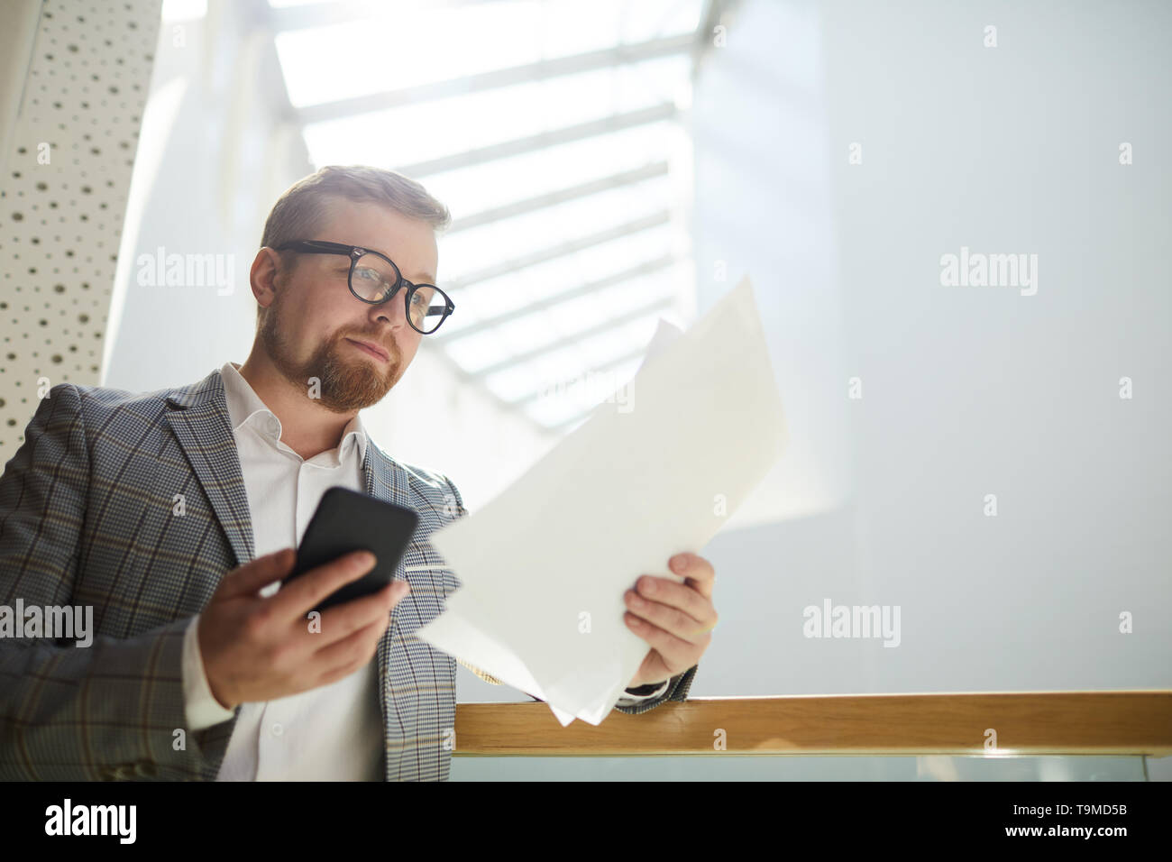 Businessman examining working paper hi-res stock photography and images ...