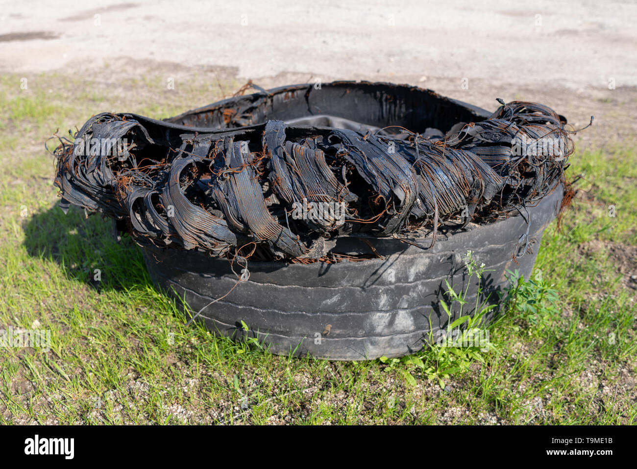 A torn tire from a truck. Old tires left on the side of the road ...