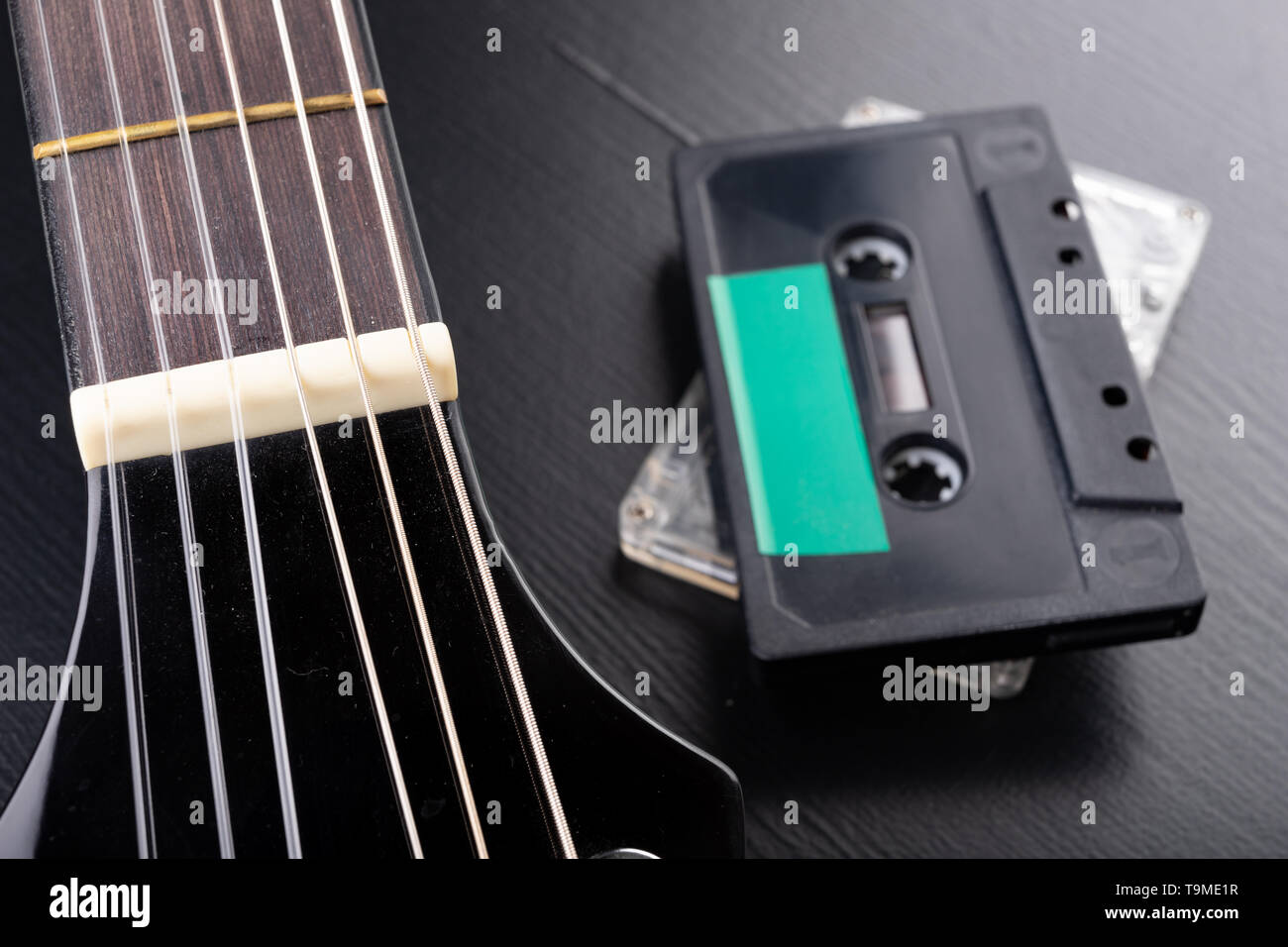 Acoustic guitar and cassette tape. Musical instrument and old music ...