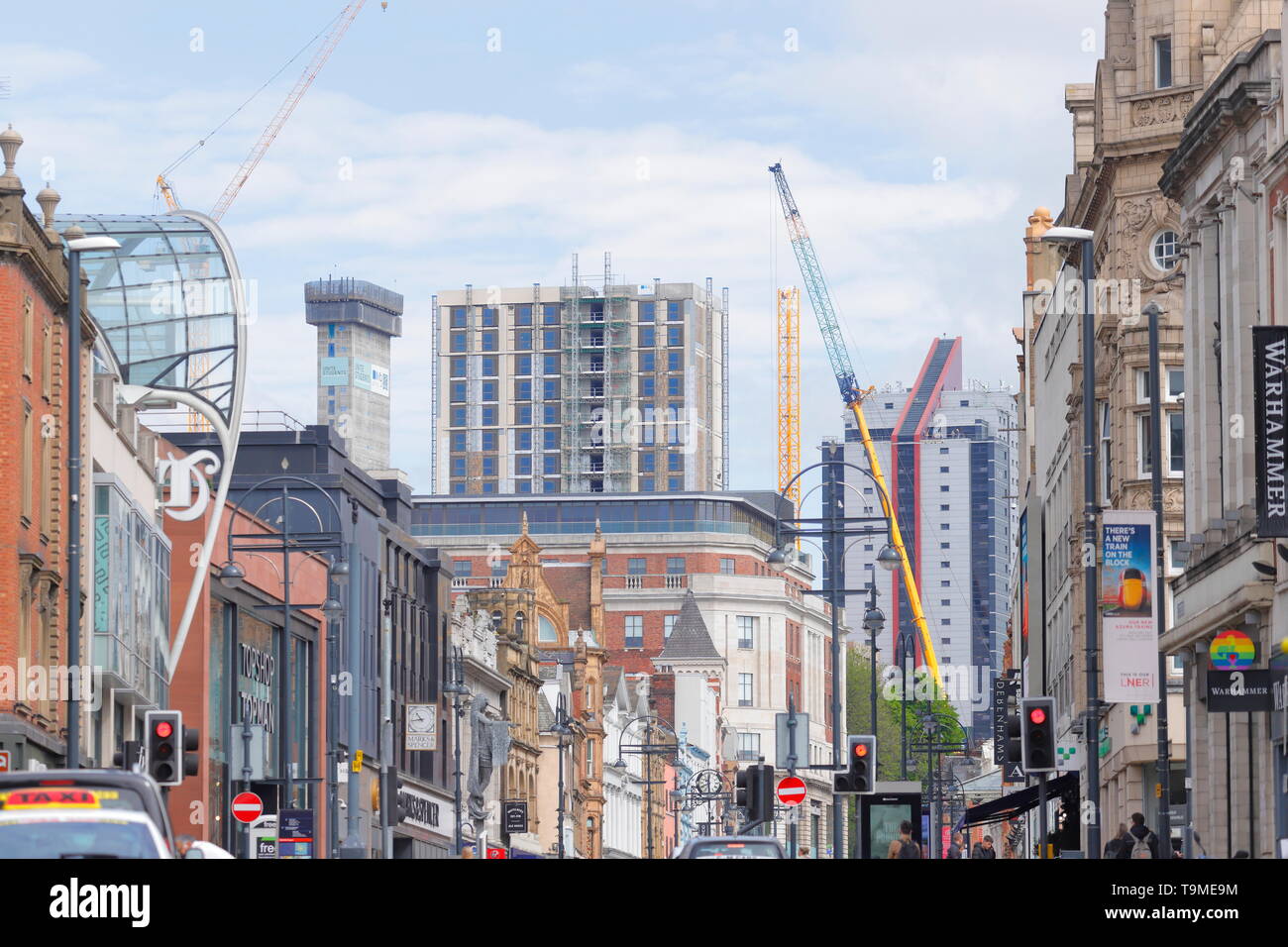 Looking up Briggate in Leeds as a new tower crane is being constructed ...