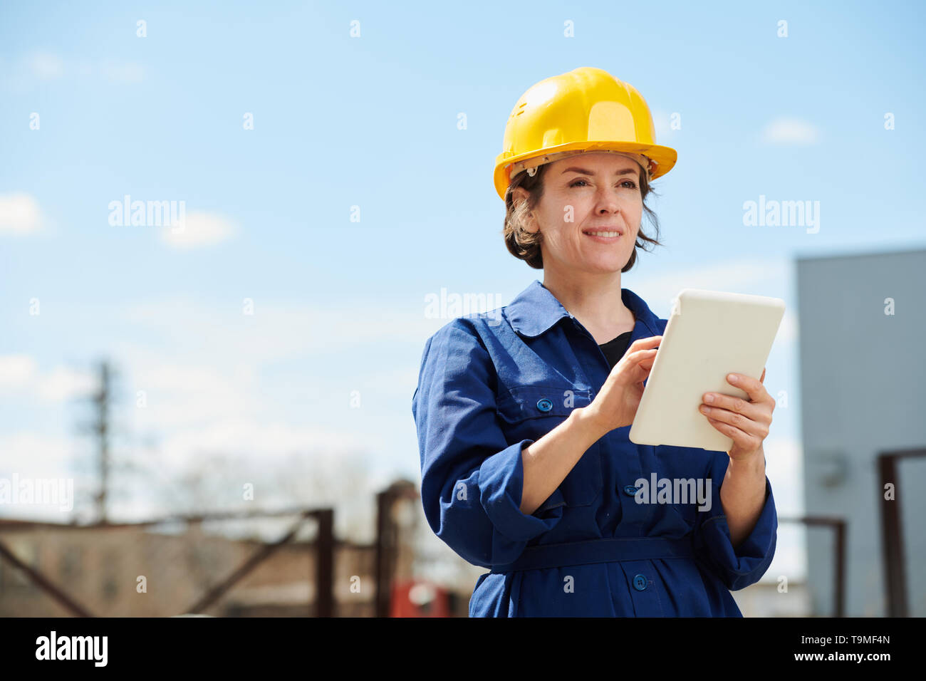 Female Worker Using Tablet Outdoors Stock Photo - Alamy