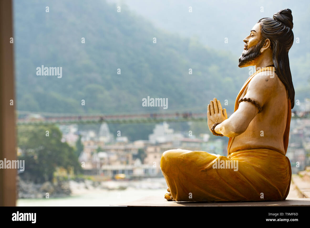 Stunning view of a sitting Hindu statue on the riverbank of the Ganges ...