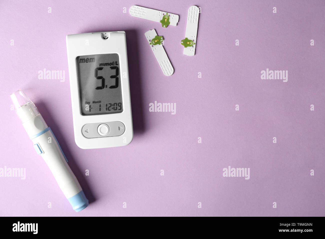 Digital glucometer with lancet pen on color background. Diabetes ...