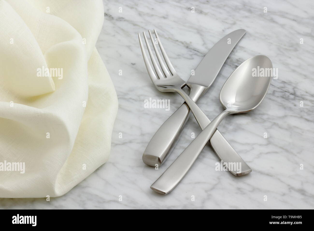 trendy and beautiful silverware set styled on linen double hemstitch ...