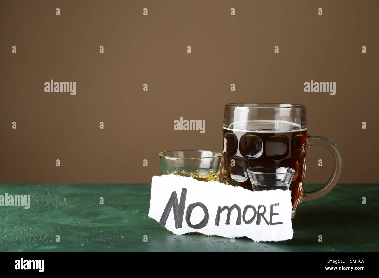 Glasses of drinks on color table. Concept of alcoholism Stock Photo - Alamy