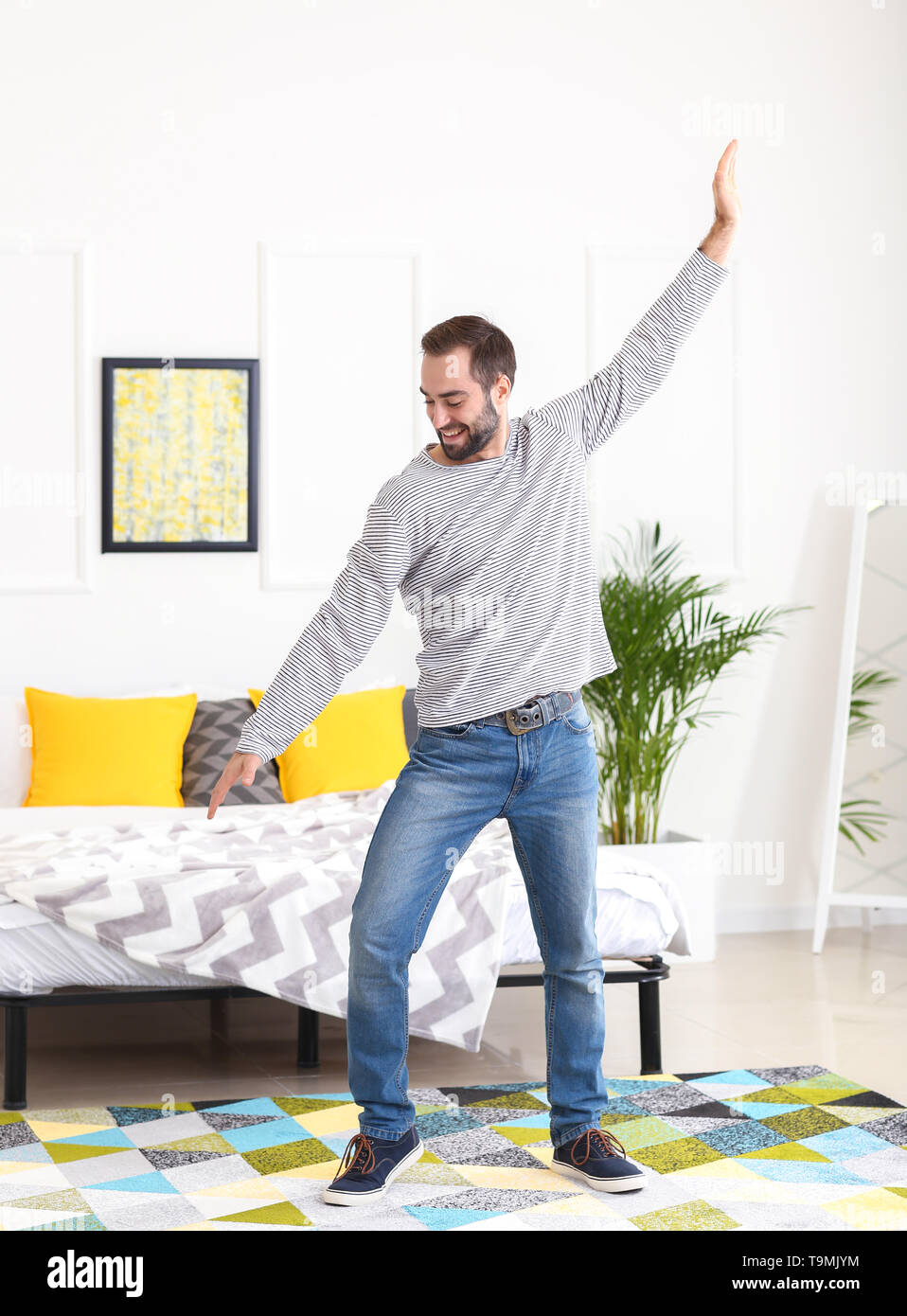 Handsome young man dancing at home Stock Photo - Alamy