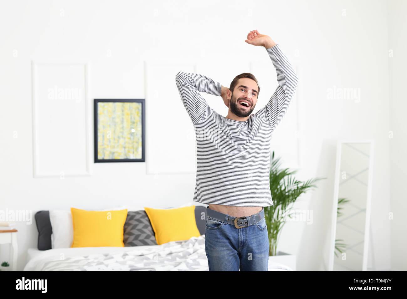 Handsome young man dancing at home Stock Photo - Alamy