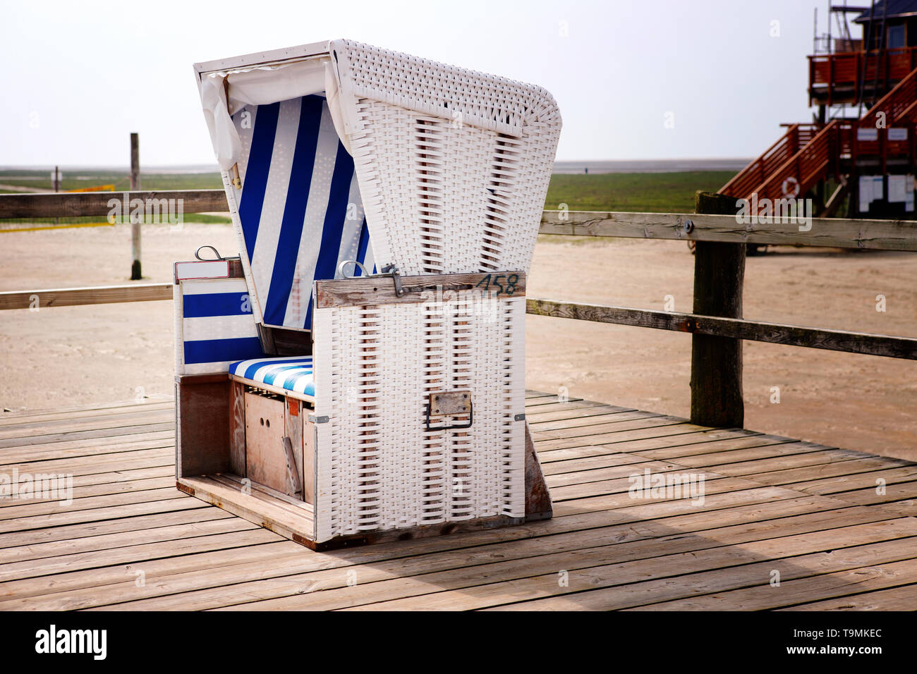 white wicker beach chair on wooden deck by the beach Stock Photo - Alamy