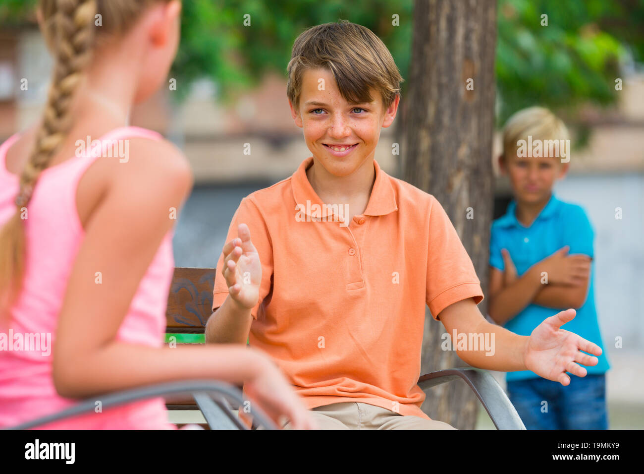 Kids are talking in the distance from their offended friend Stock Photo ...