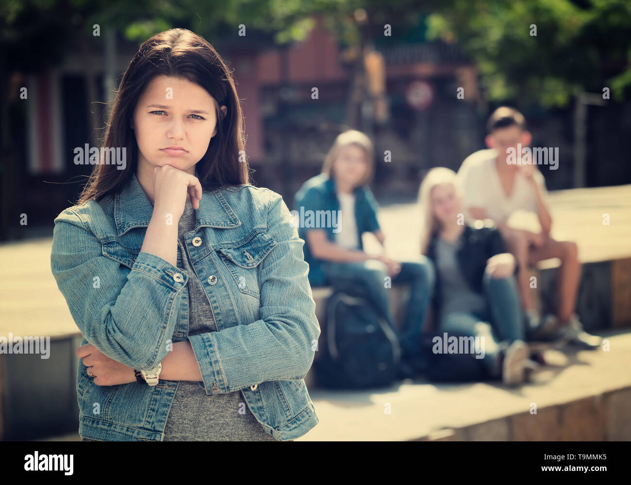 lonely teenage girl standing away from friends feeling depressed Stock ...