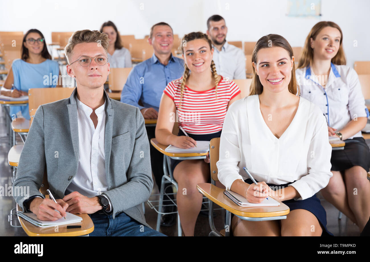 Small group of students attentively listening to lecture in classroom ...