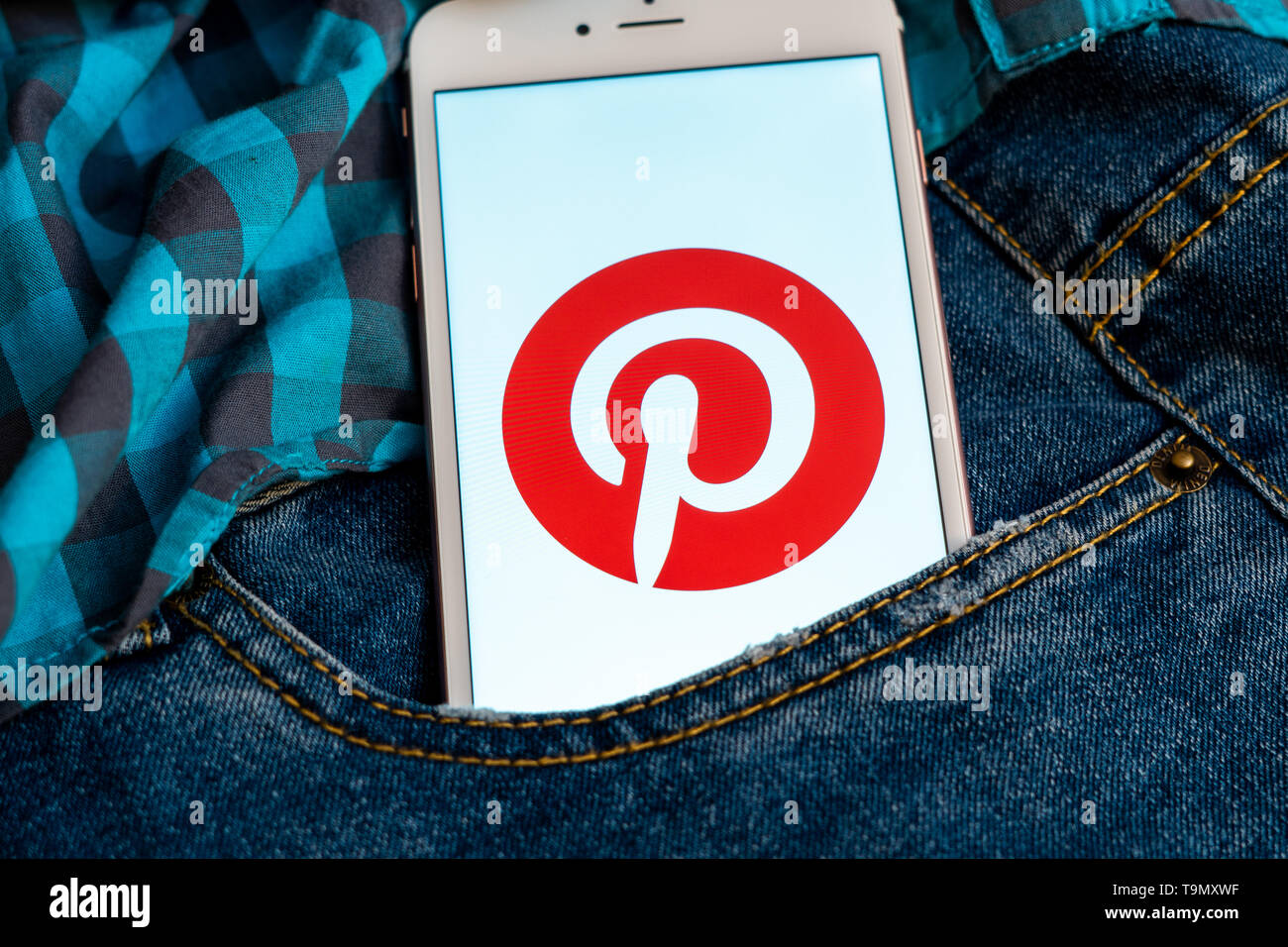 White iPhone with logo of social media Pinterest on the screen. Social ...