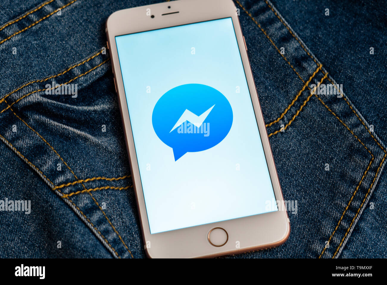 White iPhone with logo of social media Facebook Messenger on the screen ...