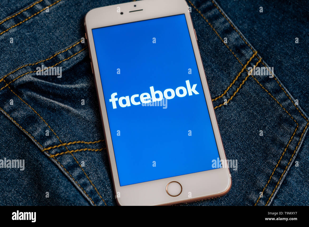 White iPhone with logo of social media Facebook on the screen ...