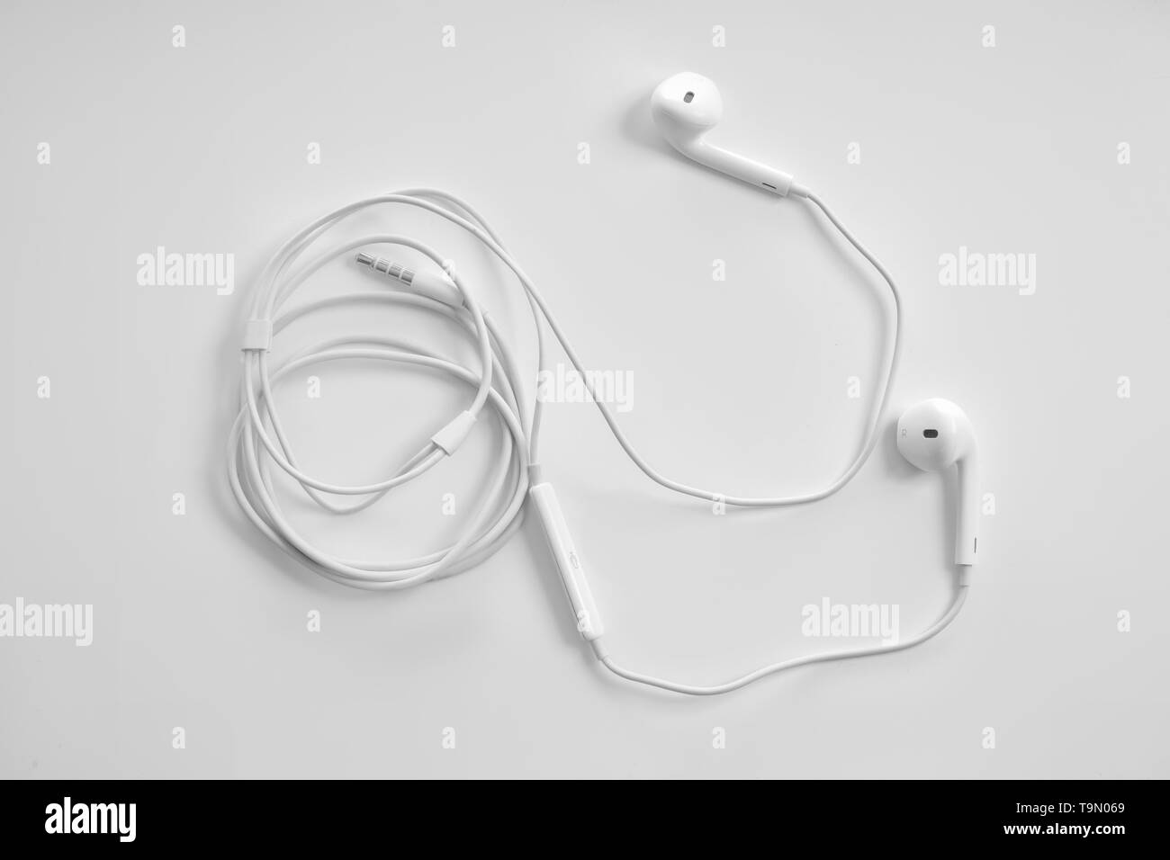 Modern earphones on white background Stock Photo - Alamy