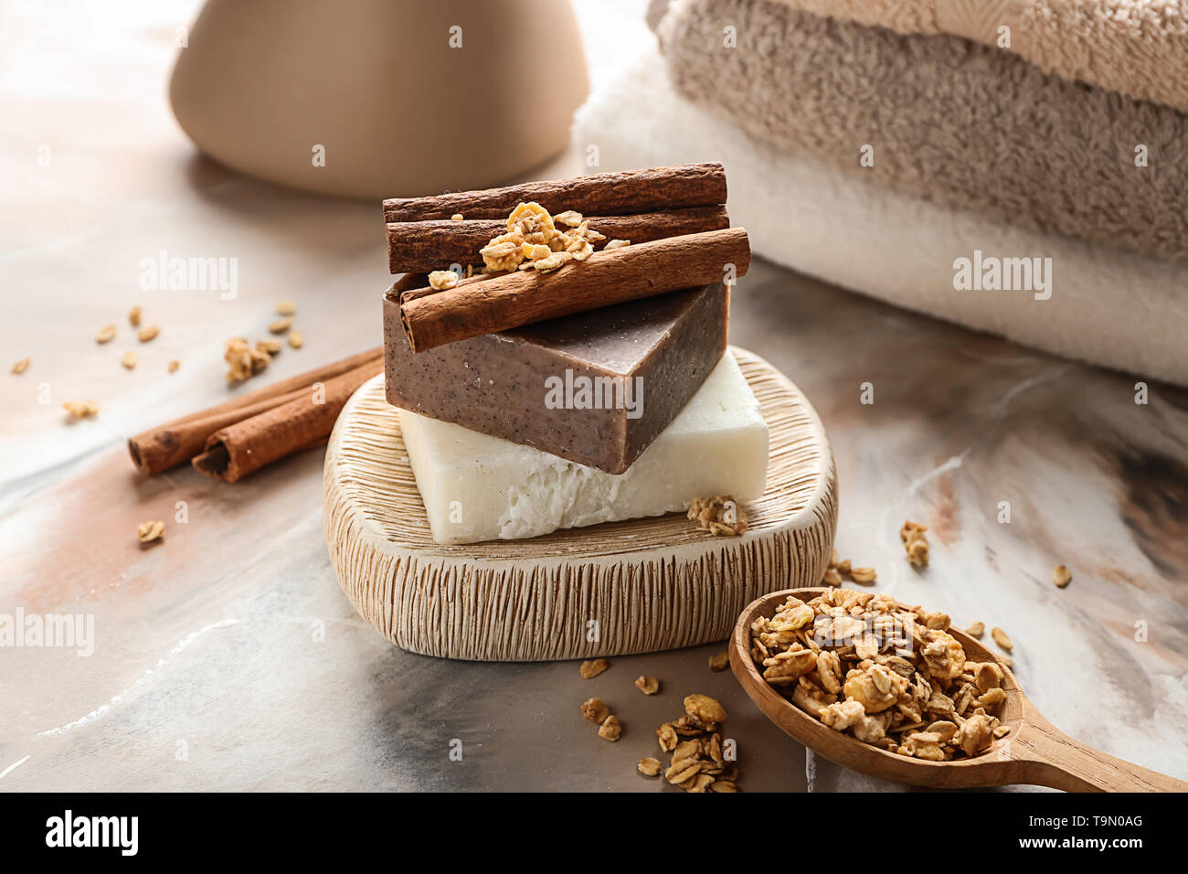 Soap bars with cinnamon sticks on color table Stock Photo - Alamy