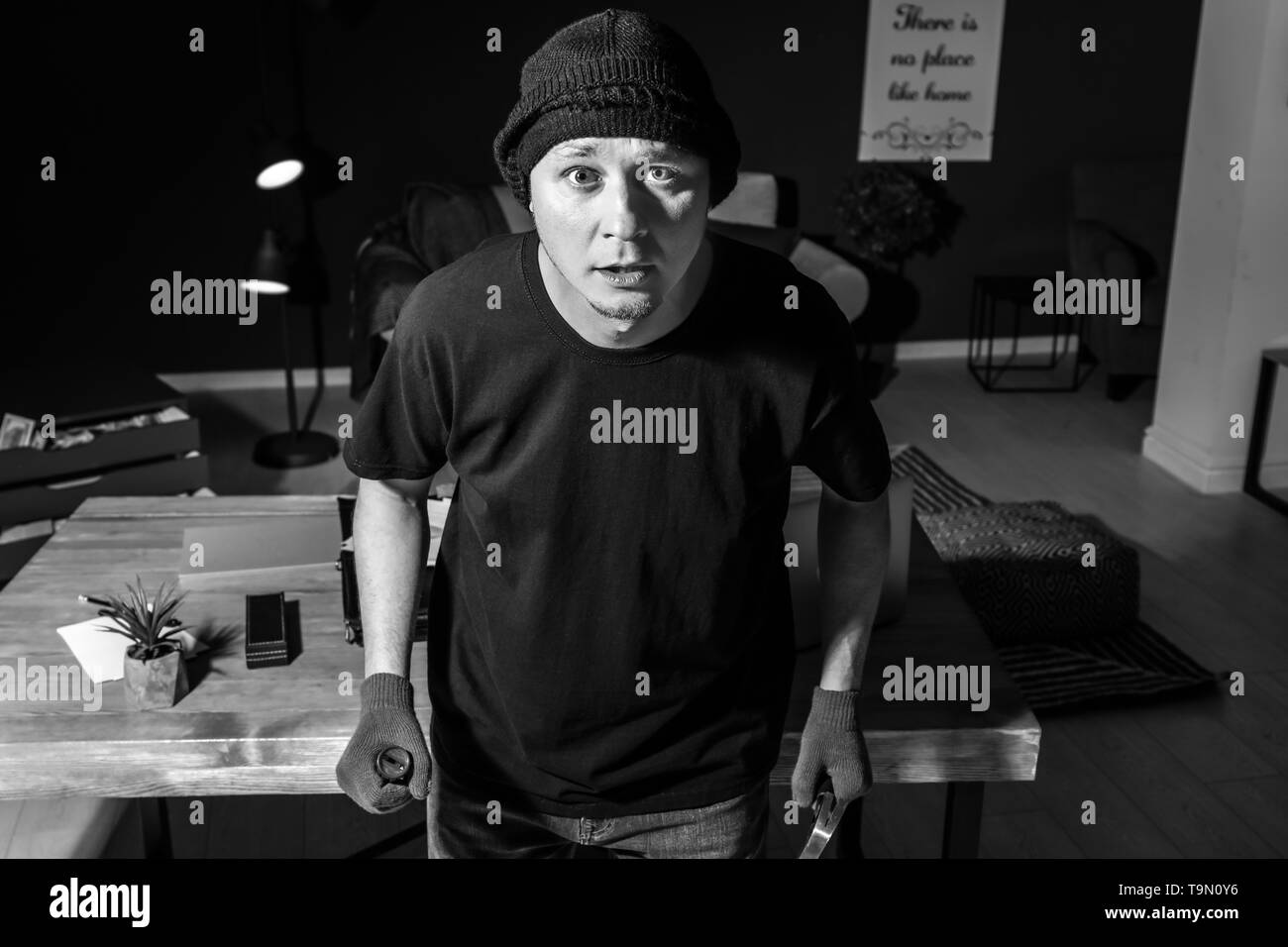 Male thief indoors, view through security camera Stock Photo - Alamy