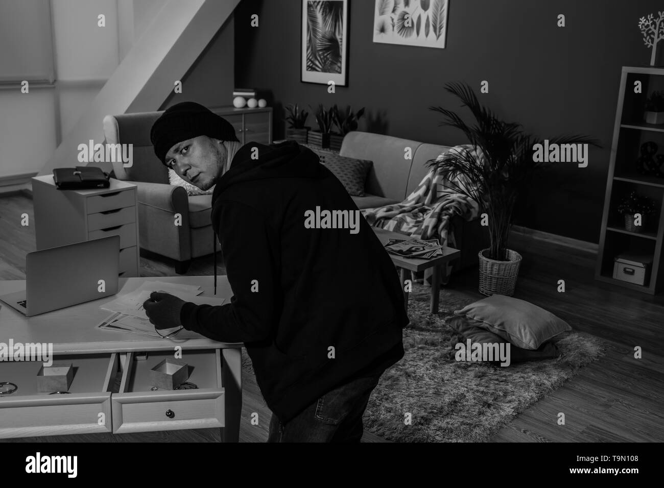 Male thief indoors, view through security camera Stock Photo - Alamy