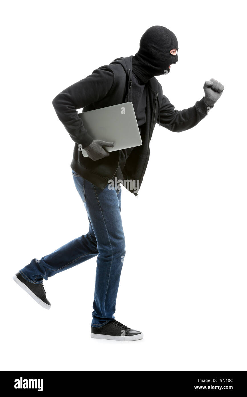 Male thief with laptop on white background Stock Photo - Alamy