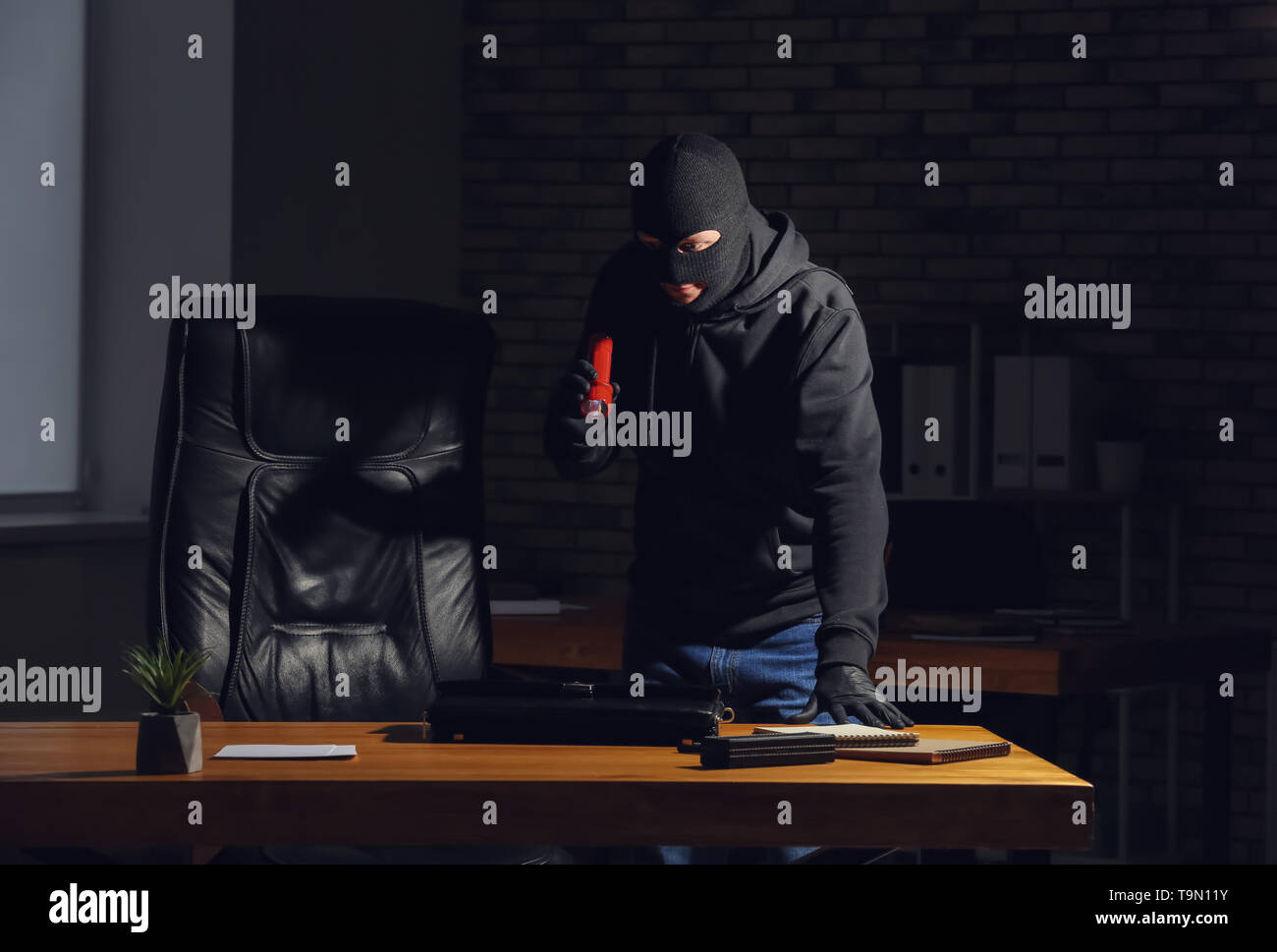 Thief in action balaclava hi-res stock photography and images - Alamy