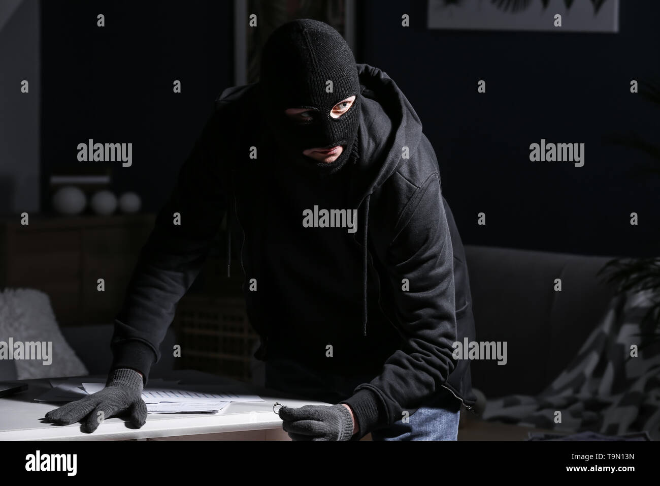 Male thief looking valuables hi-res stock photography and images - Alamy