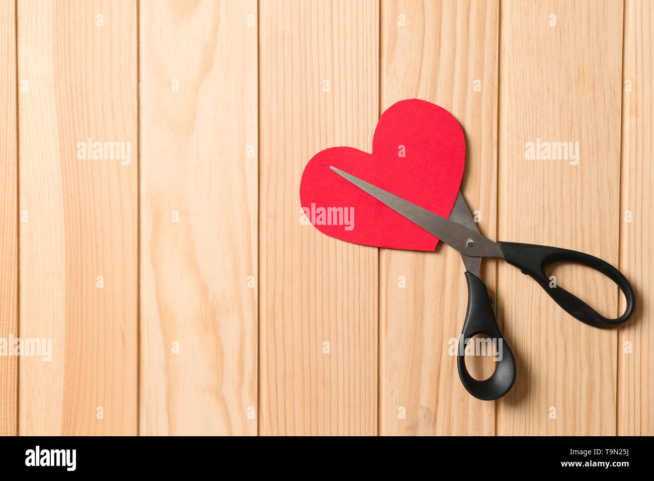 Scissors with red heart on wooden background. Concept of divorce Stock ...