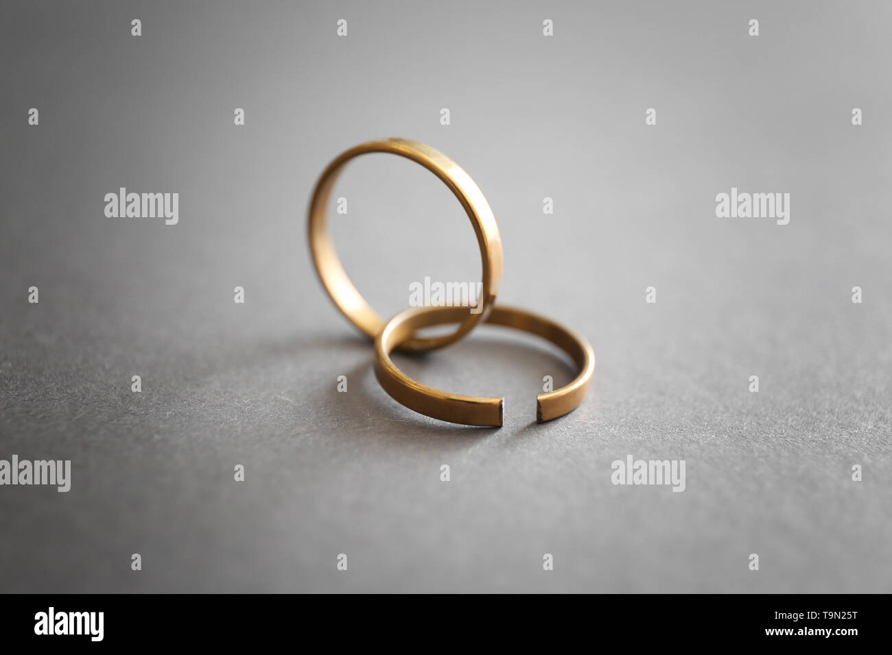 Whole and broken rings on grey background. Concept of divorce Stock ...