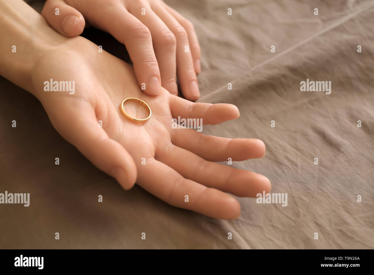Female hands with ring on cloth. Concept of divorce Stock Photo - Alamy