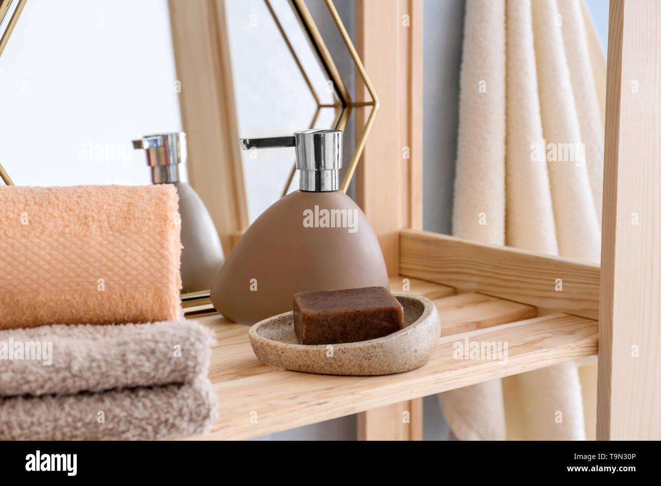 Towels and soap on shelf in bathroom Stock Photo - Alamy