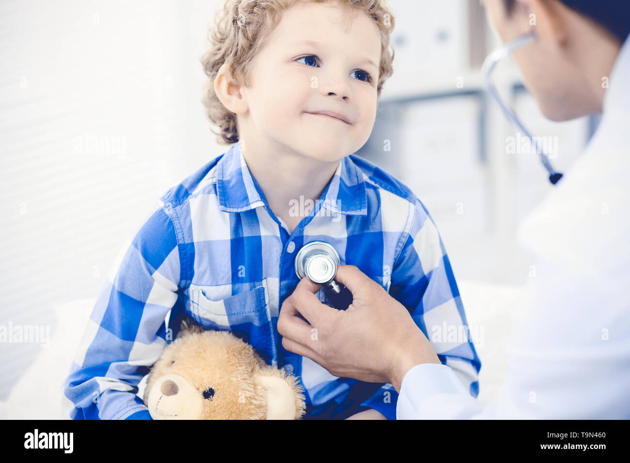 Doctor and patient child. Physician examining little boy. Regular ...