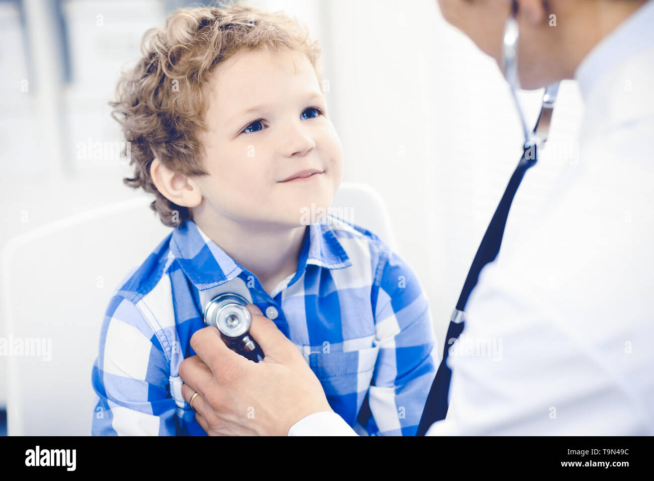 Doctor and patient child. Physician examining little boy. Regular ...