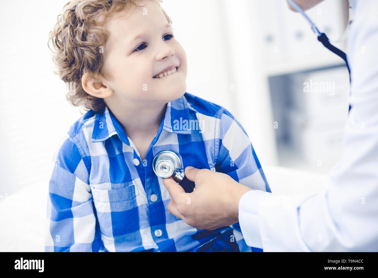 Doctor and patient child. Physician examining little boy. Regular ...