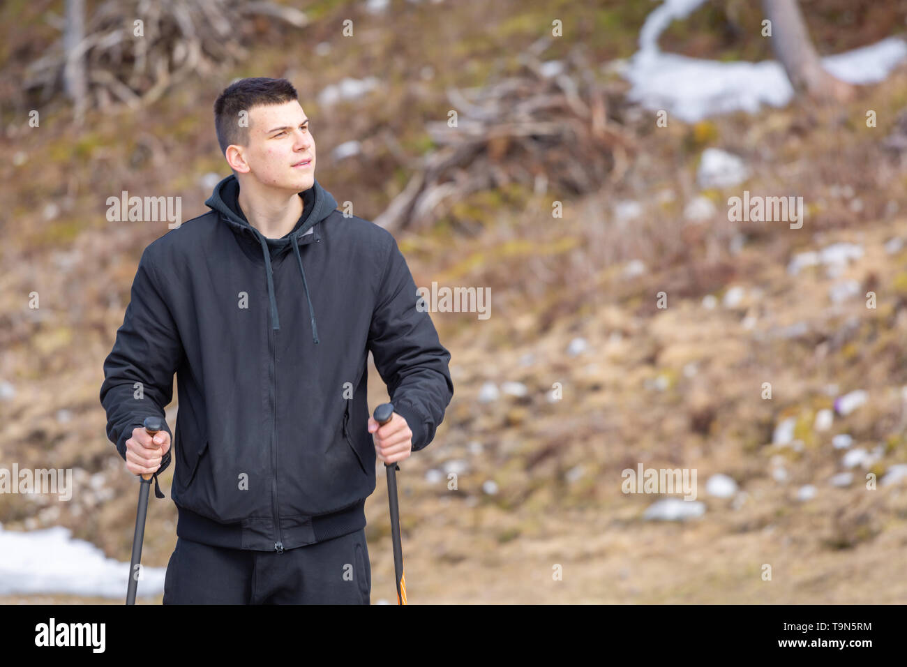Casual and active healthy man hiking in Alpine mountains with trekking ...