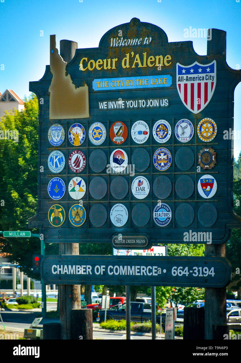 A vintage style "Welcome" sign displays badges and logos of local civic ...