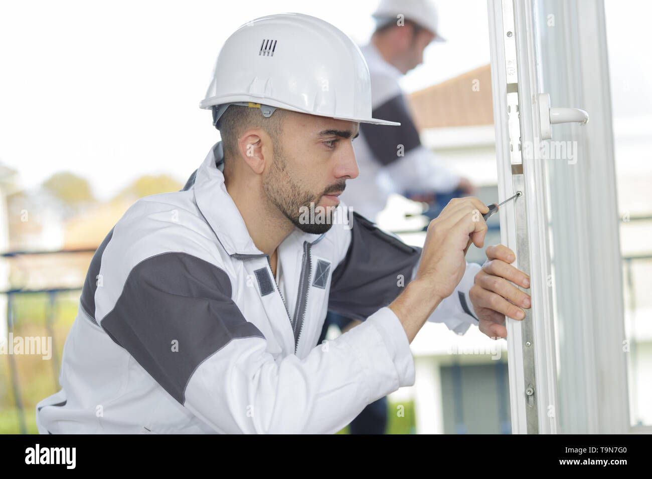 man fitting a window Stock Photo - Alamy