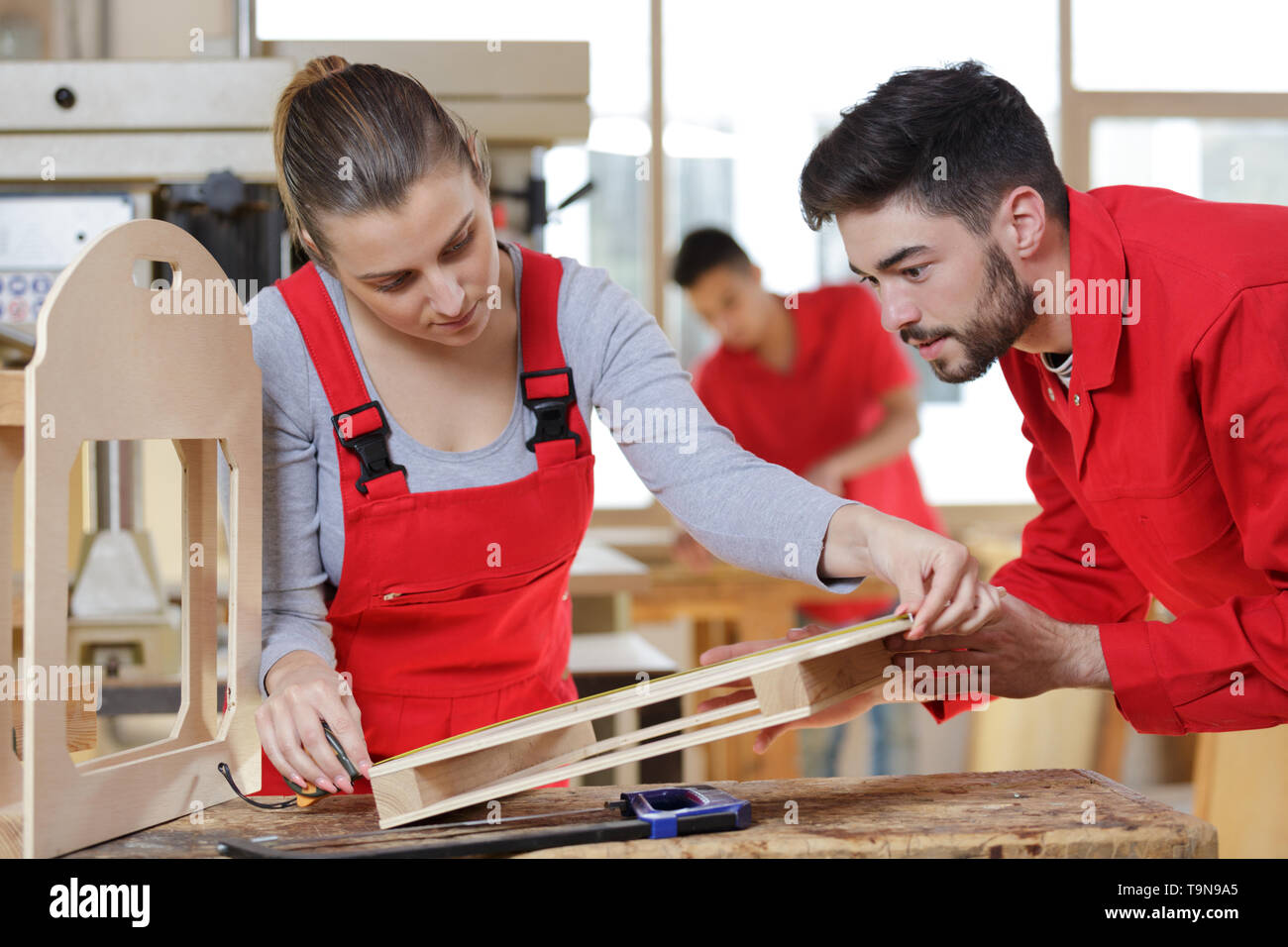 carpenter with students in workshop assembling wood Stock Photo - Alamy