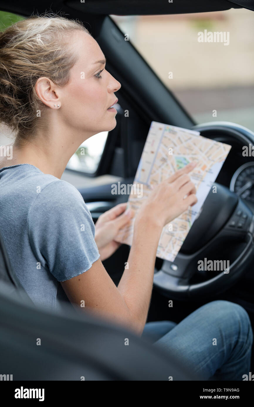 young female driver with map inside car Stock Photo - Alamy