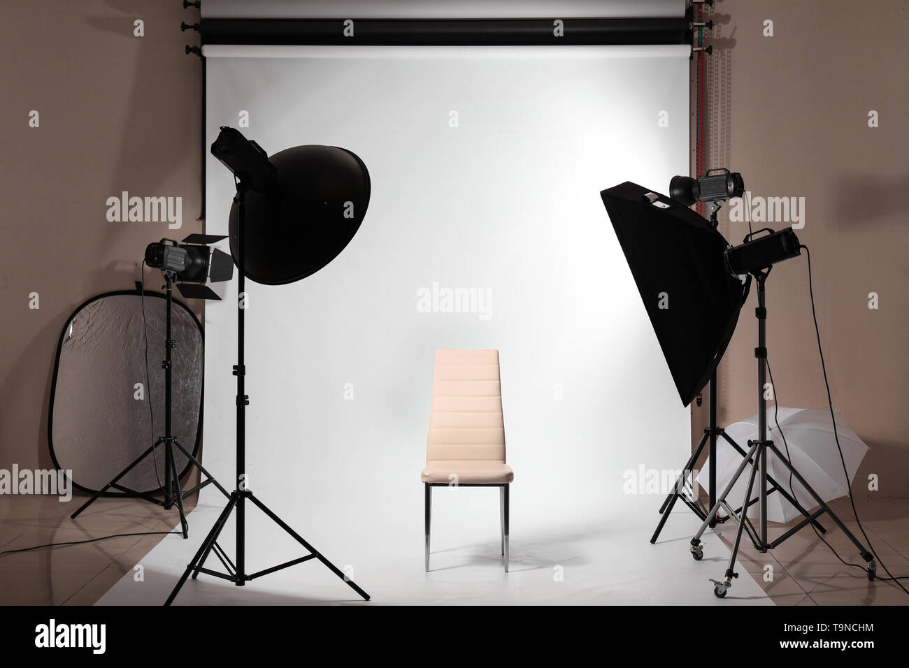 Interior of modern photo studio with professional equipment and chair ...