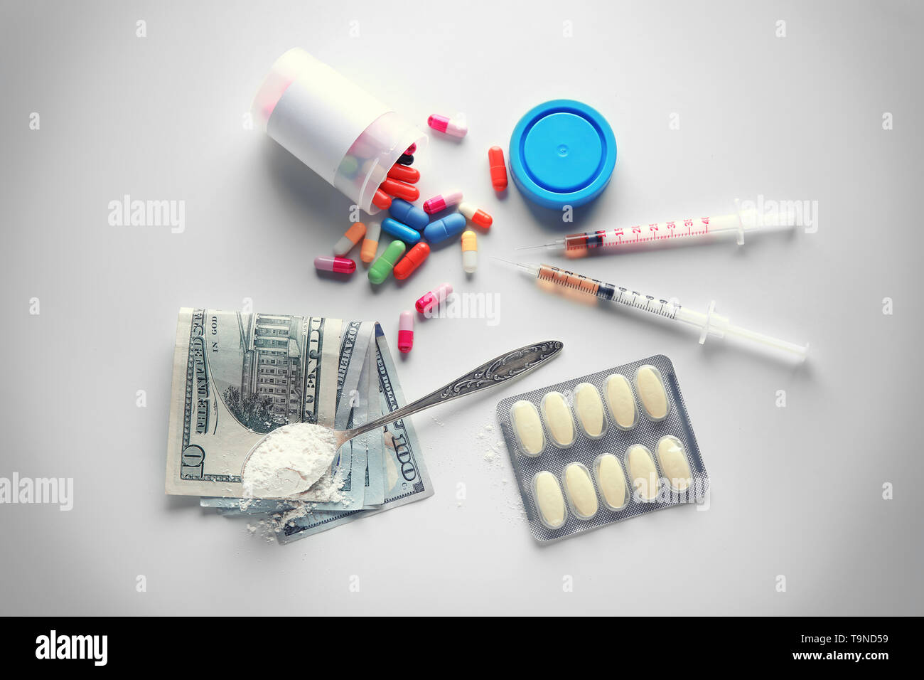 Drugs with money on white background. Concept of addiction Stock Photo ...