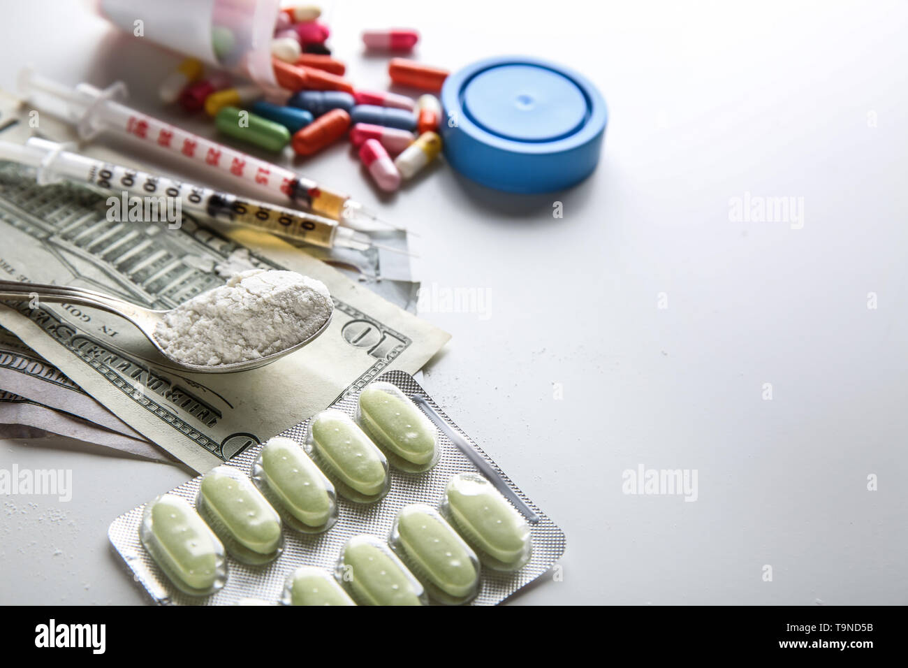 Drugs with money on white background. Concept of addiction Stock Photo ...