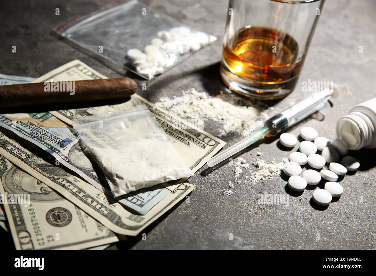 Drugs, alcohol and money on grey background. Concept of addiction Stock ...
