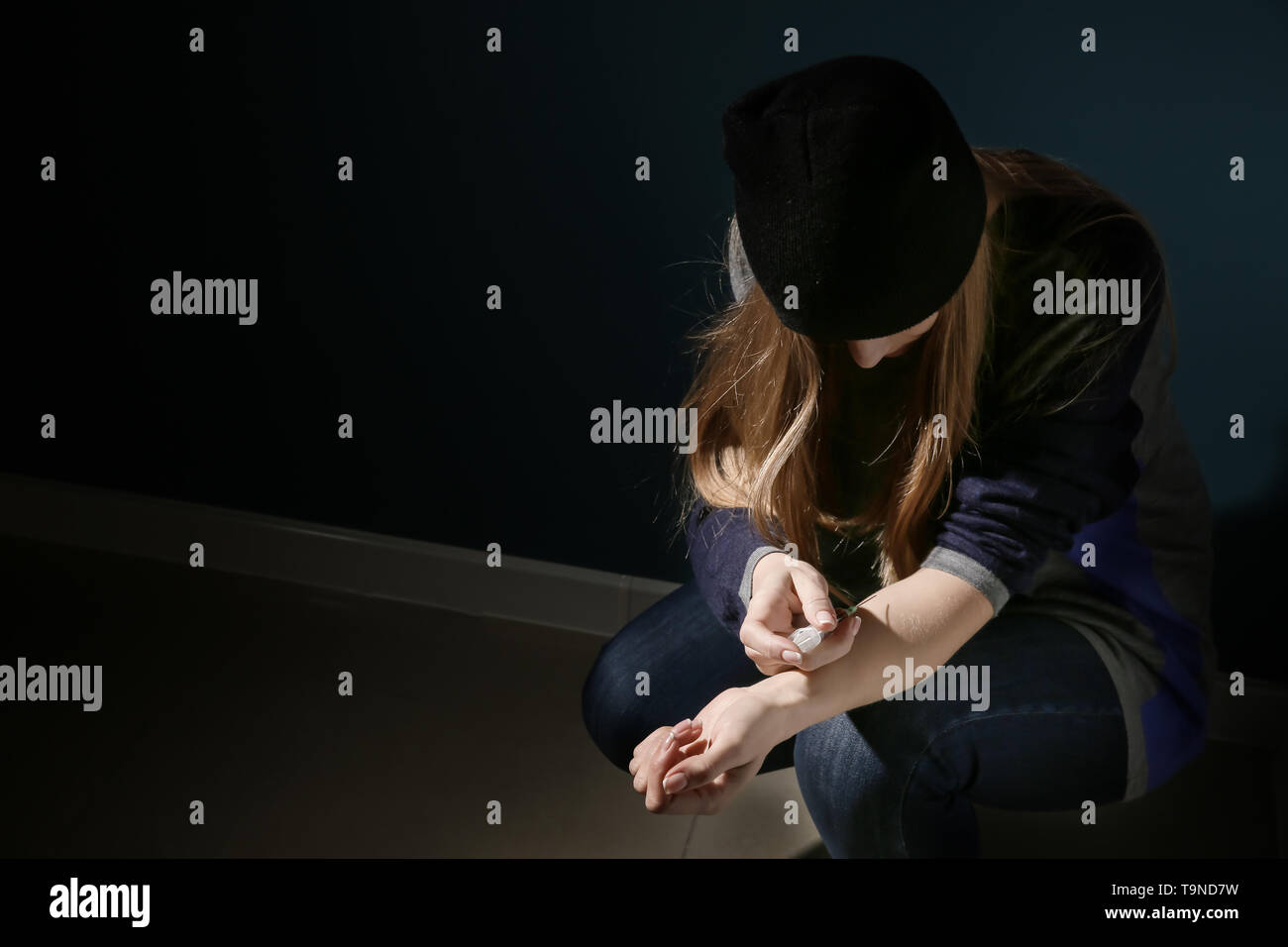 Female junkie with syringe near color wall. Concept of addiction Stock ...