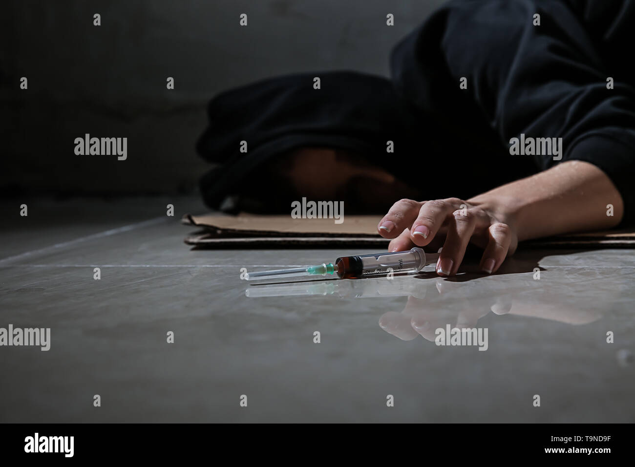 Female junkie lying on floor after taking drugs. Concept of addiction ...