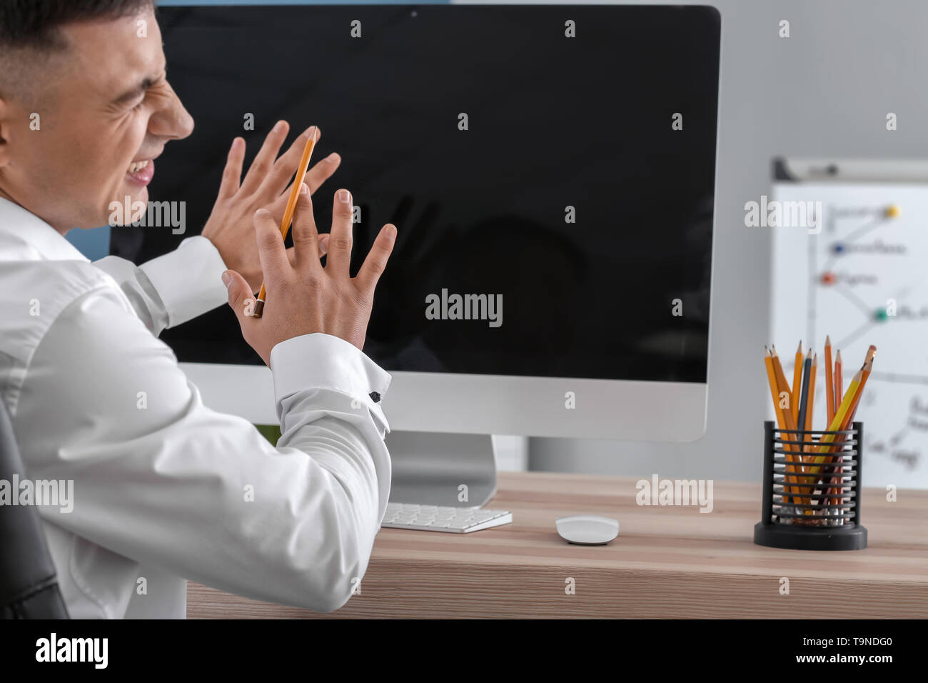 Emotional young man after making mistake during work with computer ...