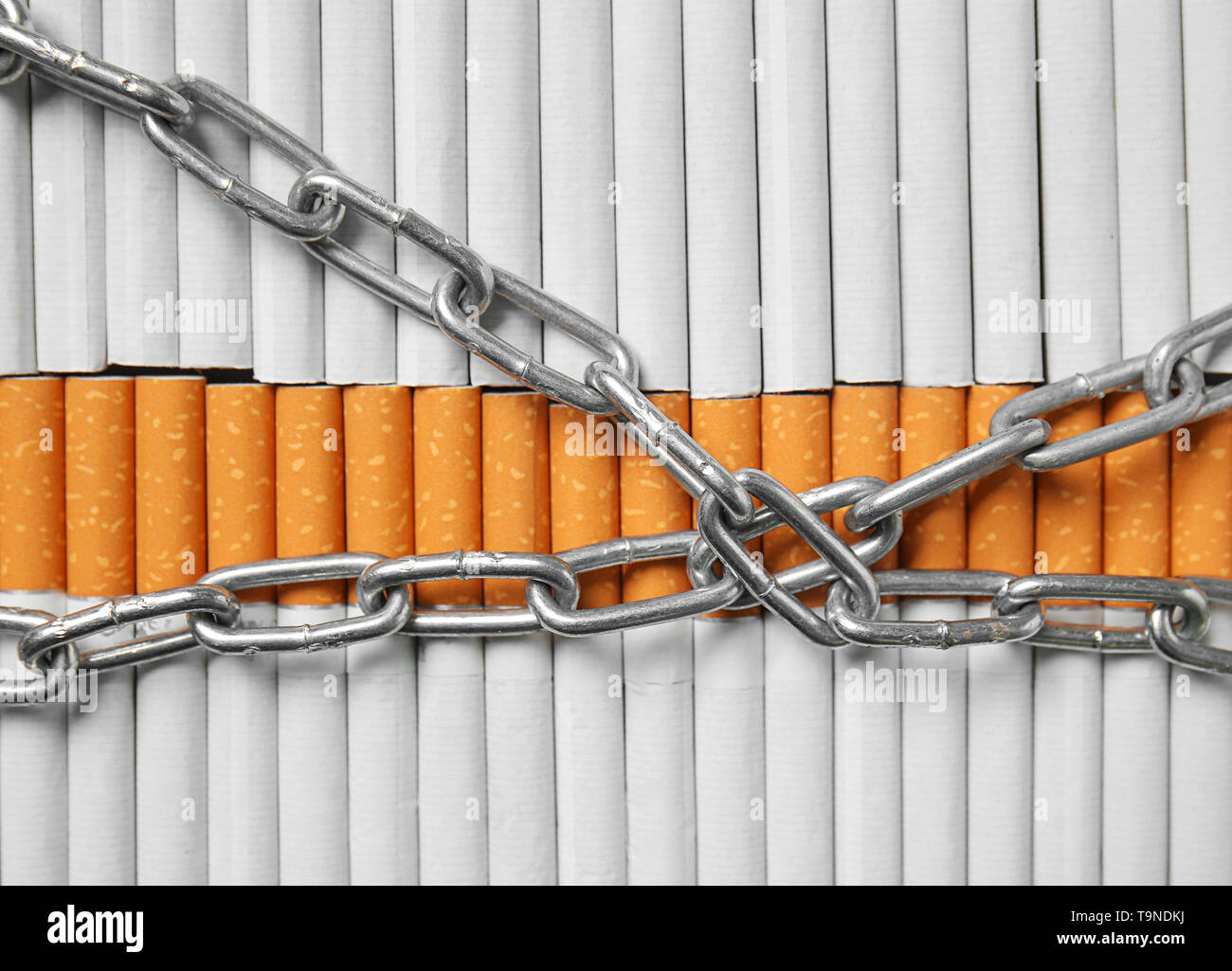 Cigarettes with crossed chain, closeup. Concept of addiction Stock ...