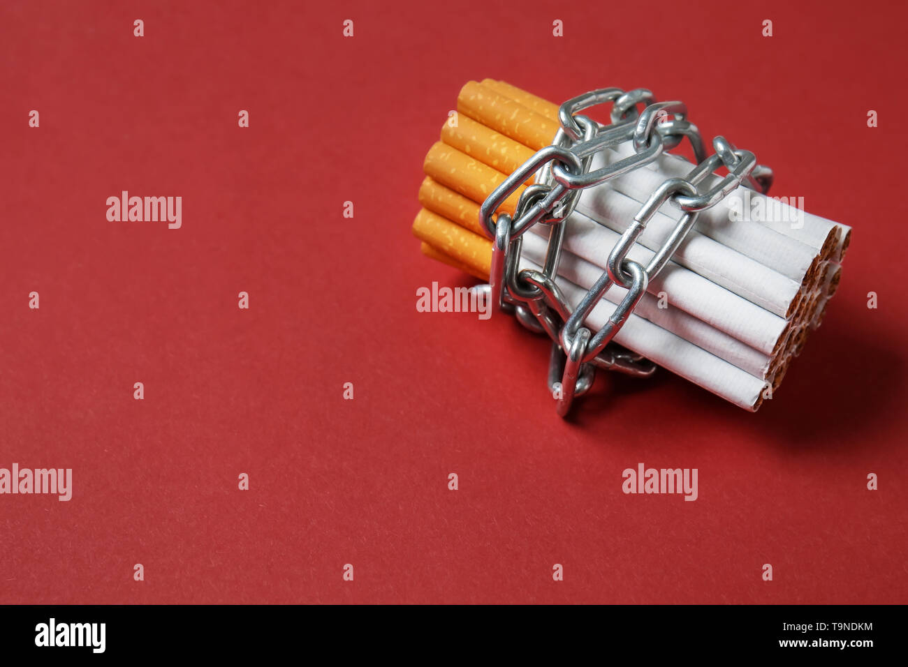 Cigarettes with chain on color background. Concept of addiction Stock ...