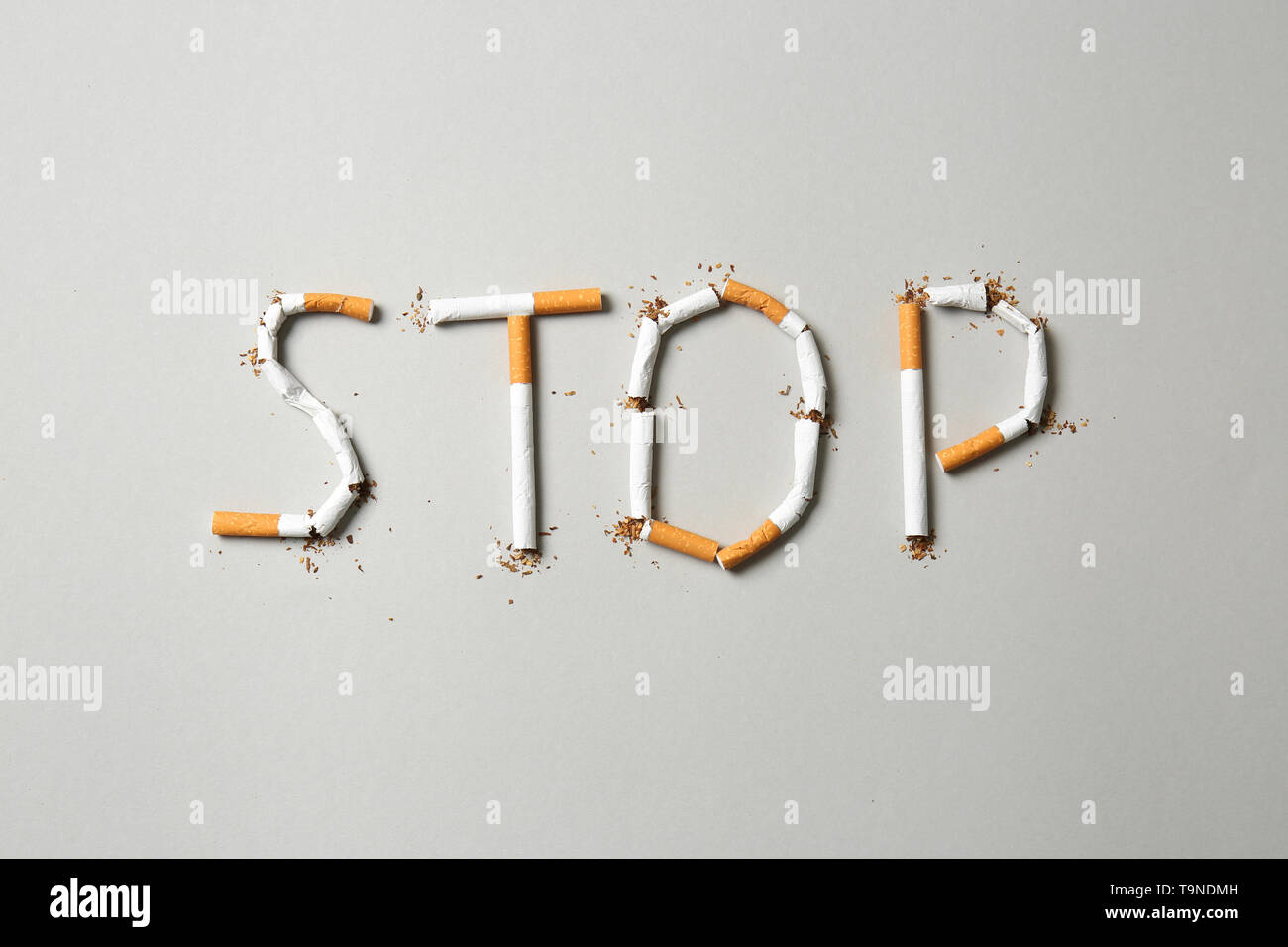 Word STOP made with cigarettes on grey background. Concept of addiction ...