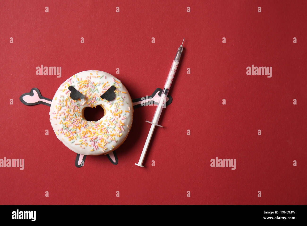 Angry doughnut with syringe on color background. Concept of addiction ...