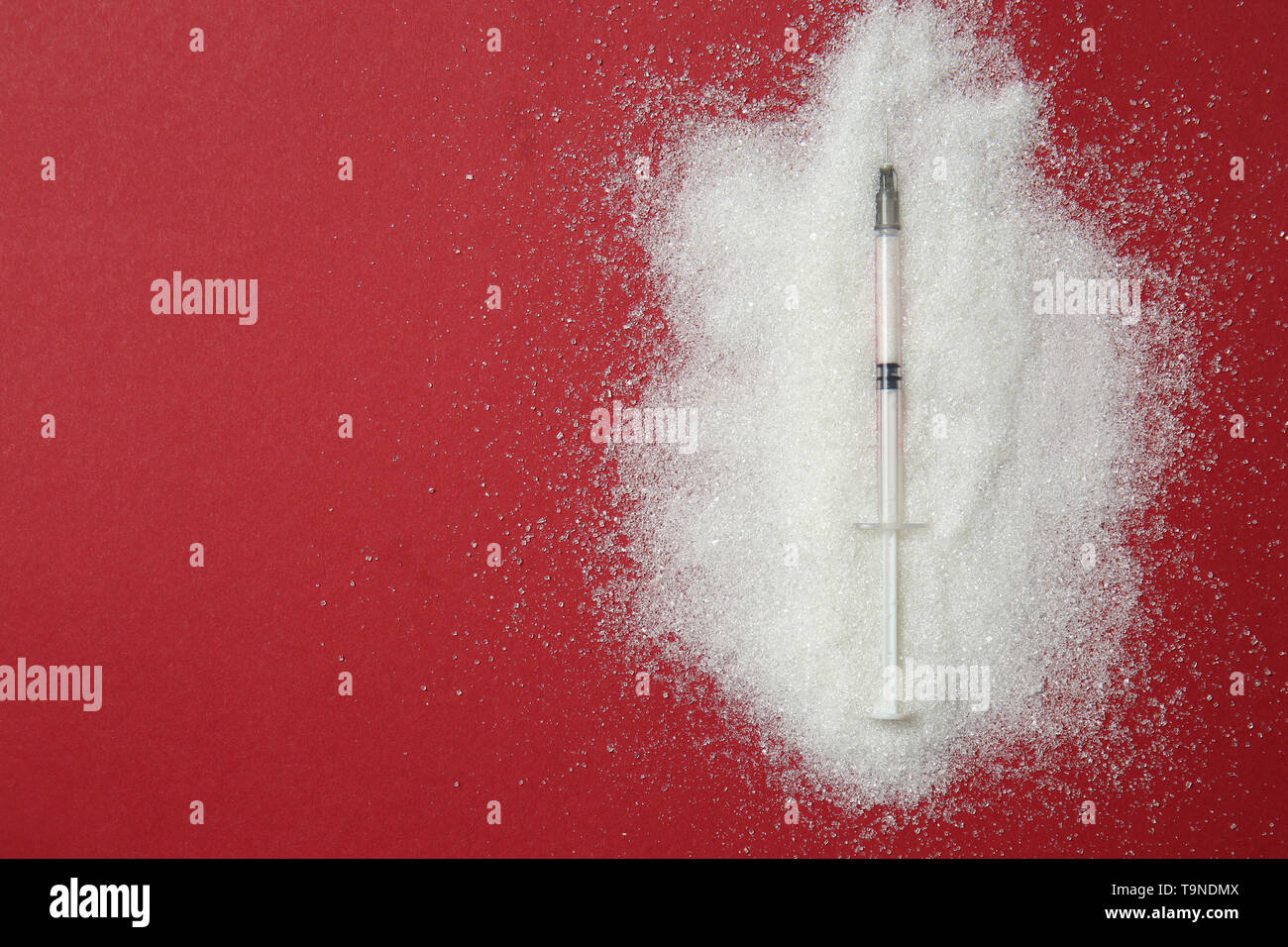 Syringe with sugar on color background. Concept of addiction Stock ...