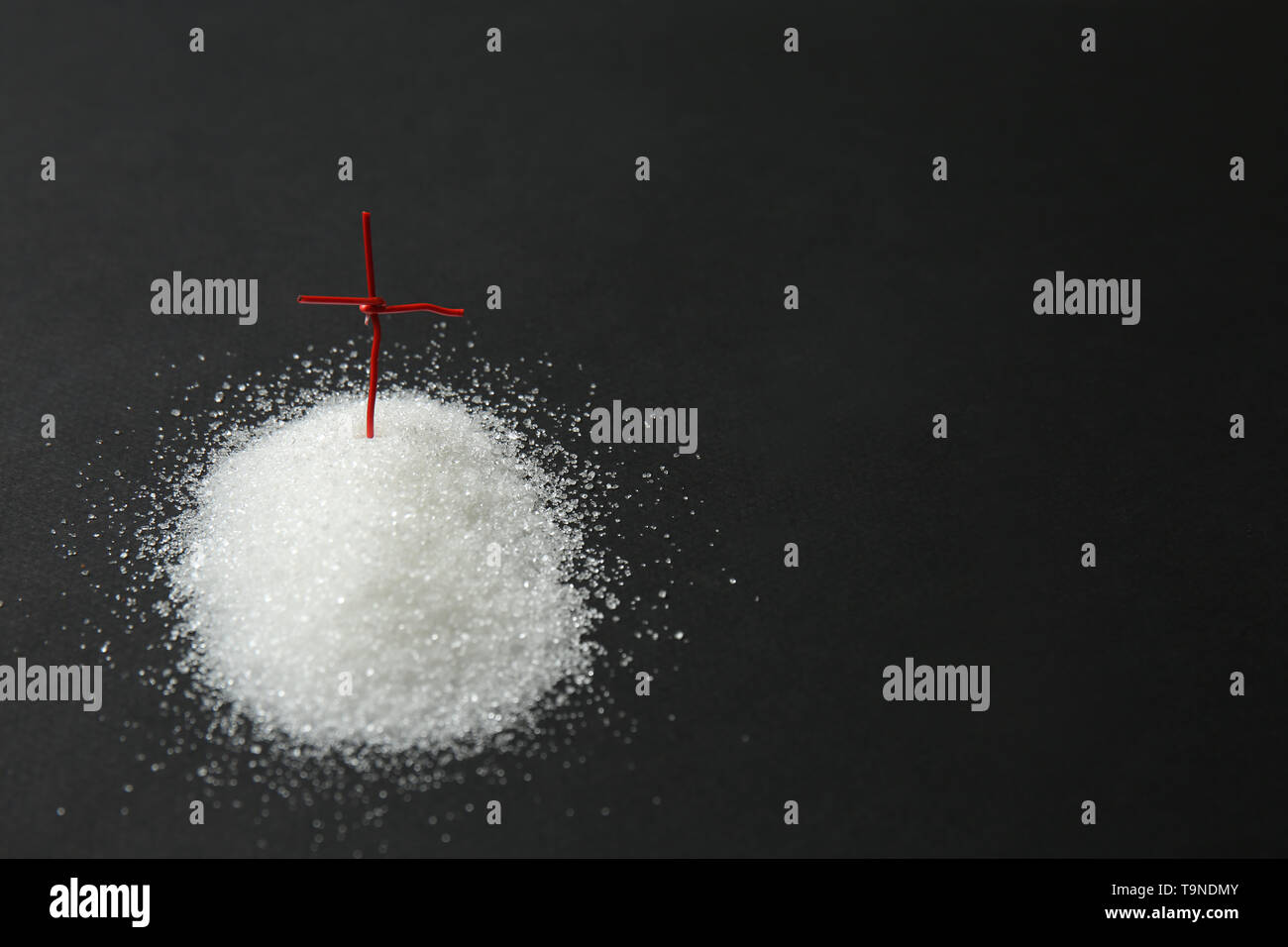 Heap of sugar with cross on dark background. Concept of addiction Stock ...